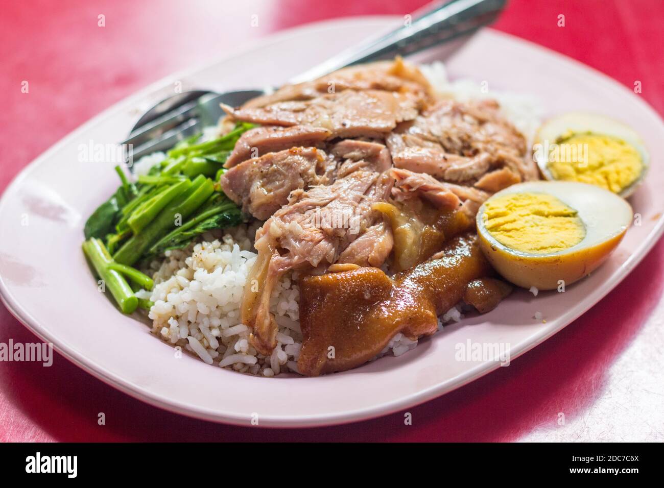 Kao ka moo, a popular Thai street food dish of slow braised pork leg in ...