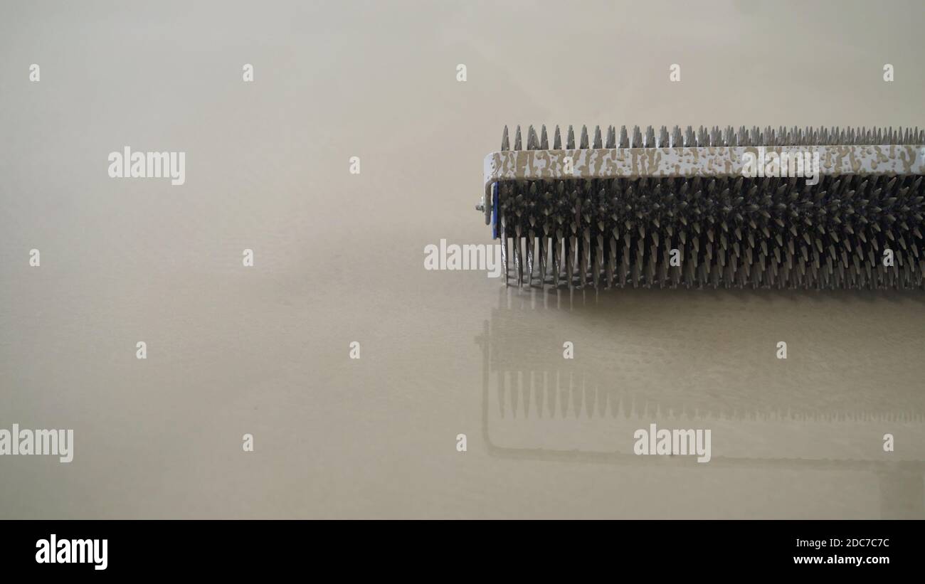 Charcoal roller on the self-leveling floor. Charcoal roller. Self ...