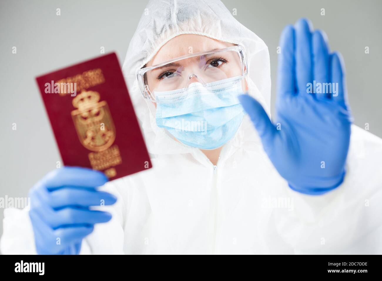 Security officer at airport customs security check holding passport, no ...