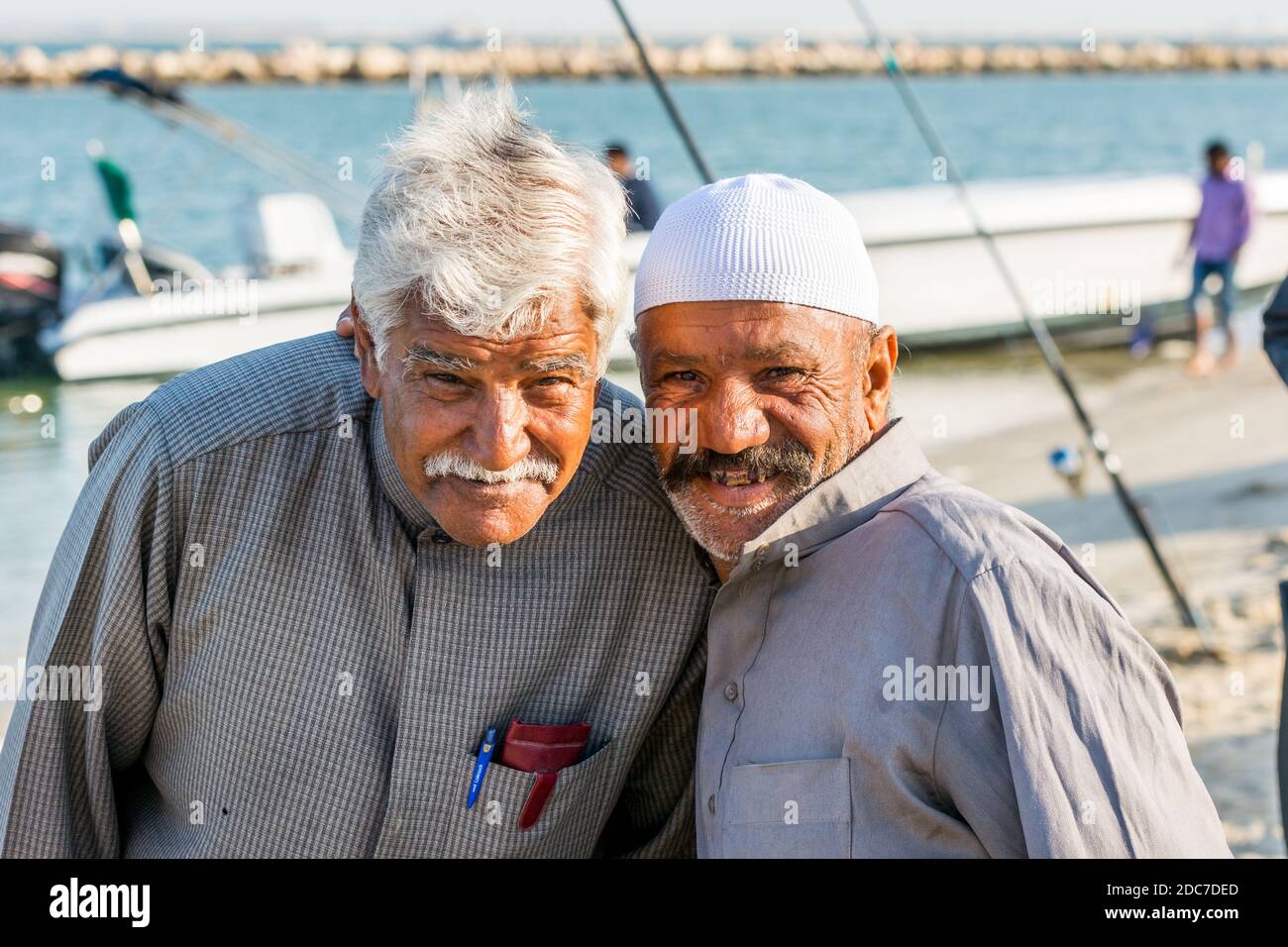 Two mid-aged Saudi Arabian men fishing at the beach of corniche park ...