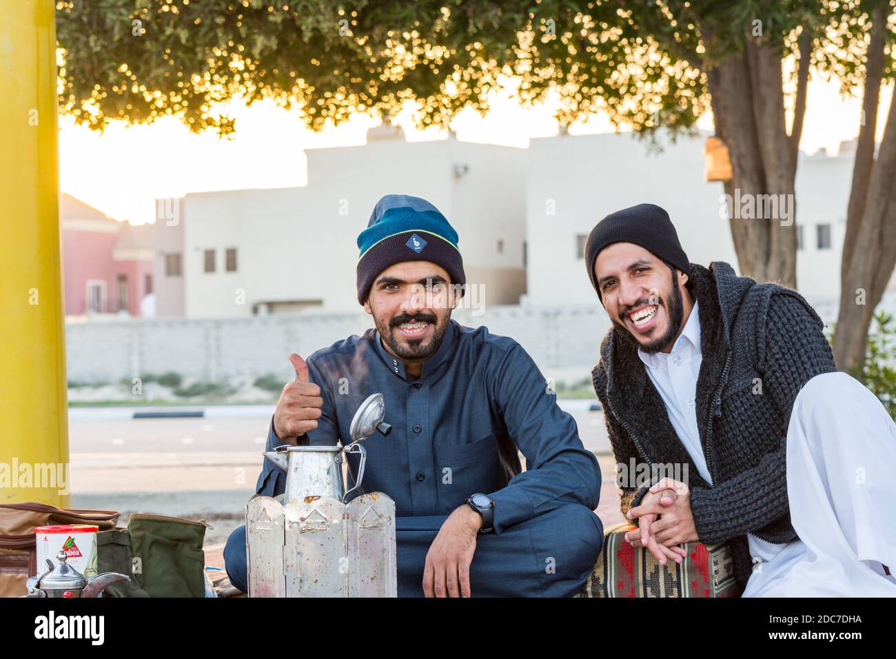 Two young Saudi Arabian men sitting at the beach of corniche park ...