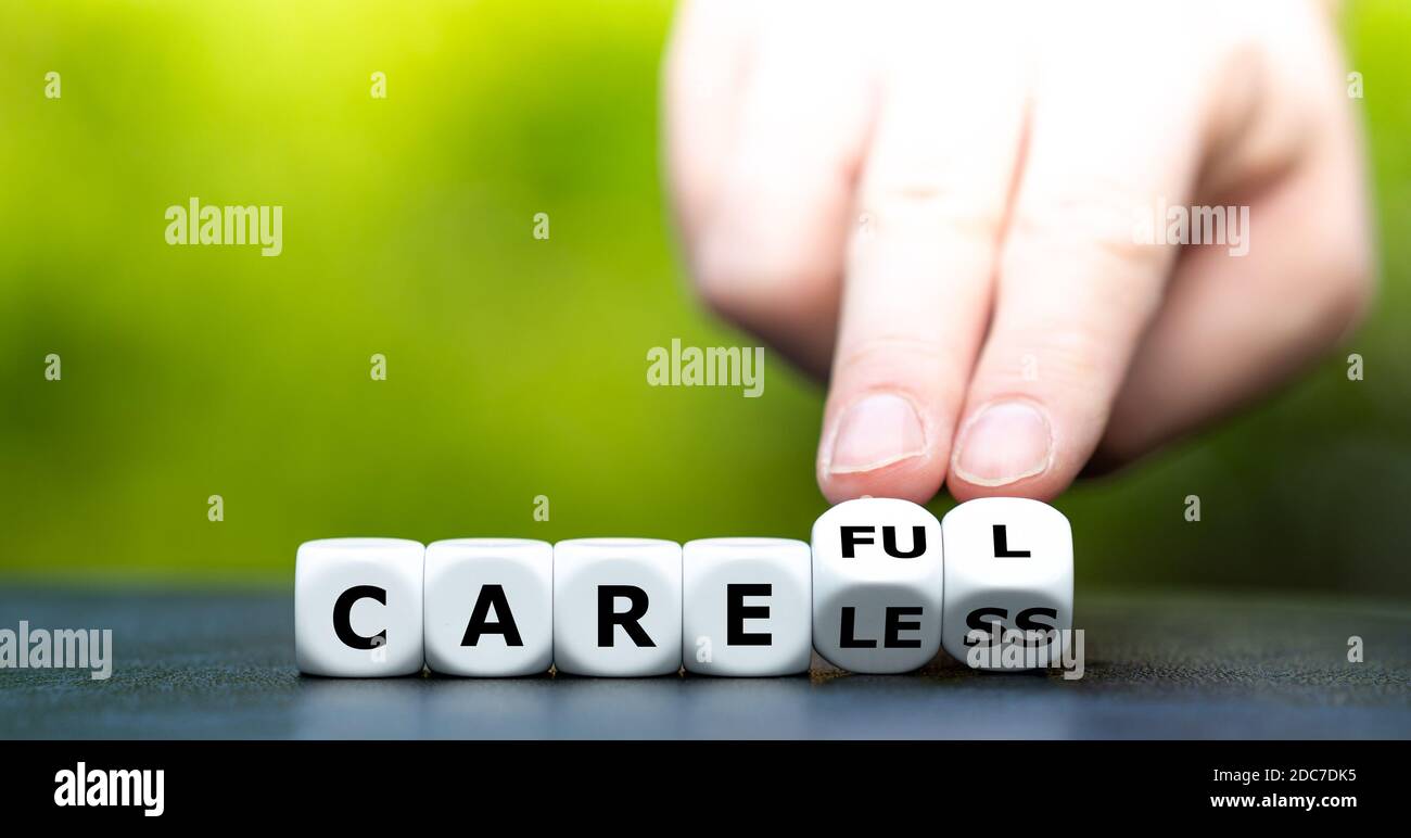 Hand turns dice and changes the word "careless" to "careful Stock Photo ...