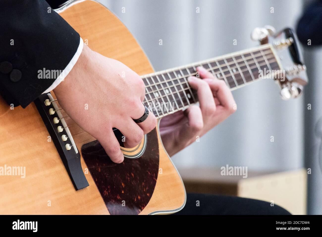 A close-up of a male hand plucking a western guitar Stock Photo - Alamy