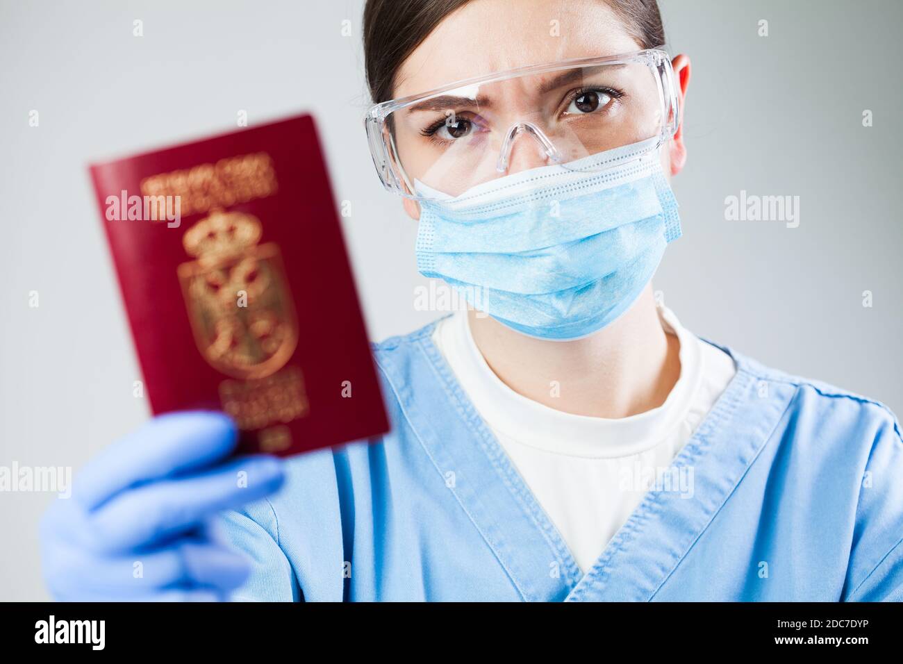Doctor or nurse at airport customs security check holding a passport ...