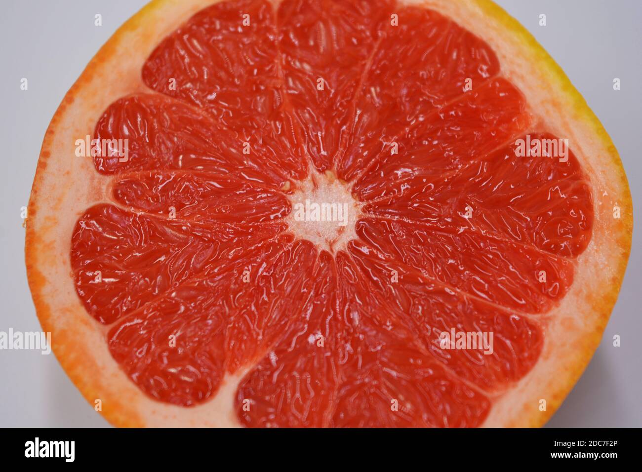 Halves of ripe juicy grapefruit, halved, set on a white background ...