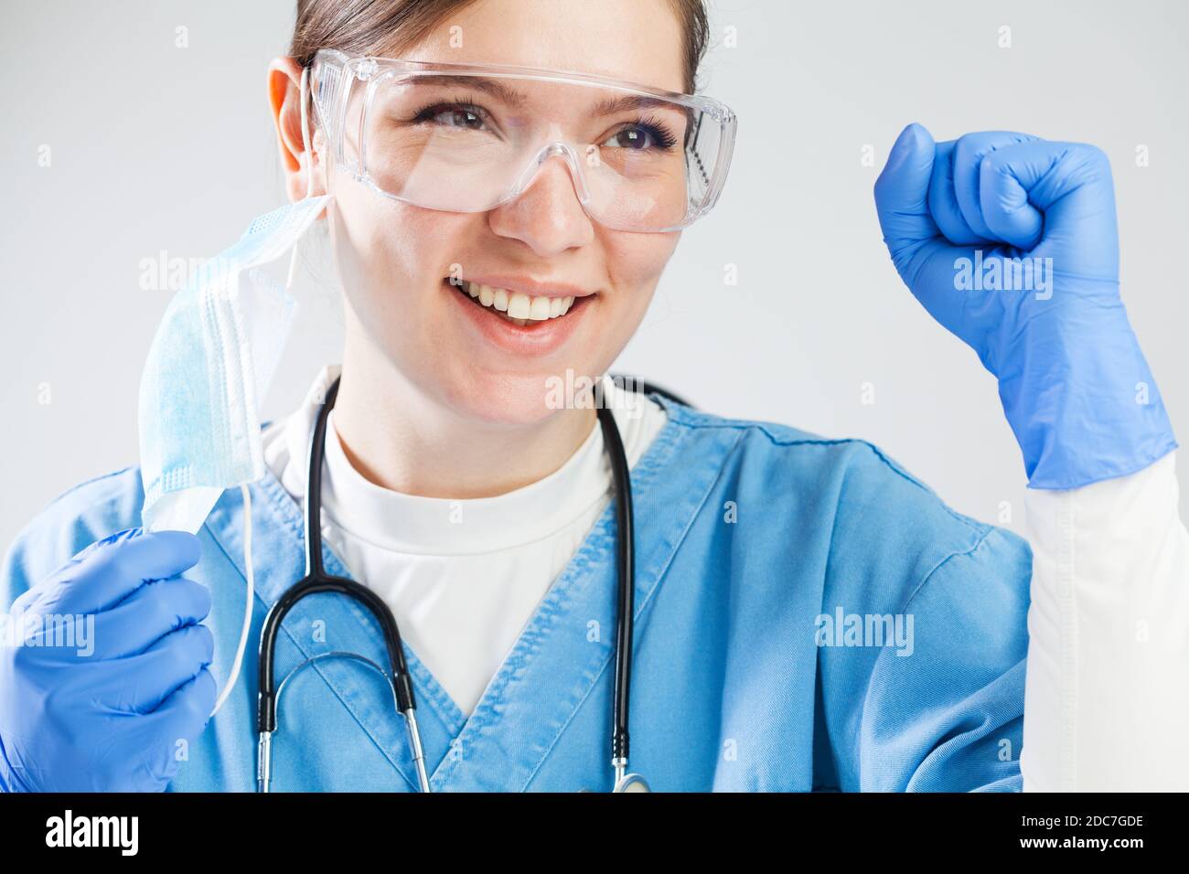Victorious doctor with clenched fist and raised arm, celebrating ...