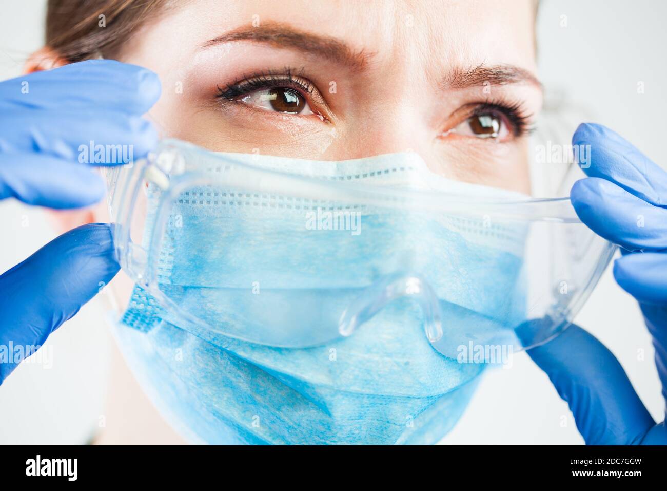 Desperate devastated female doctor,eyes full of tears,crying & grieving ...