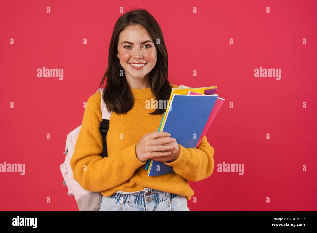 Image of happy beautiful student girl posing with exercise books ...