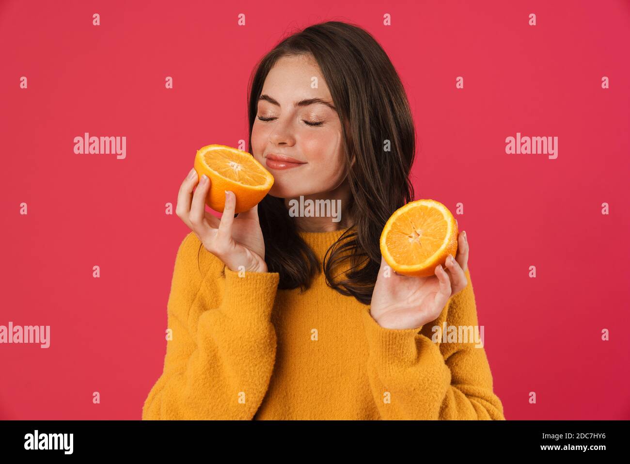 Image of happy caucasian girl smiling while smelling orange isolated ...