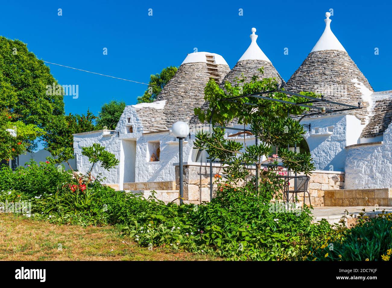 Olive trees and trulli of the Itria valley. Puglia Stock Photo - Alamy