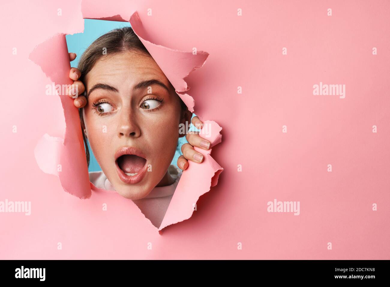 Caucasian young excited woman screaming and looking at copyspace ...