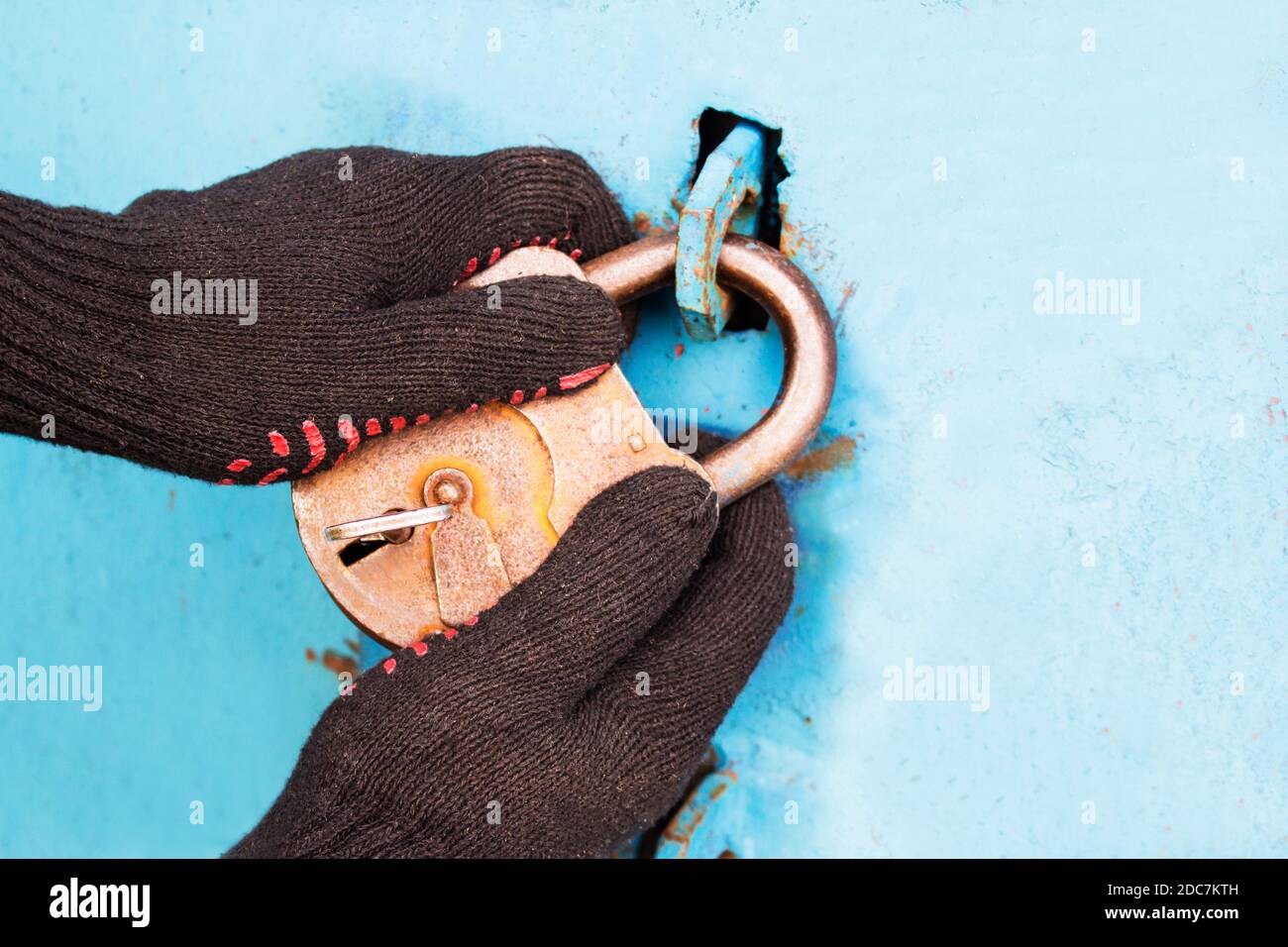 The thief opens the old lock. Safe storage of property Stock Photo - Alamy