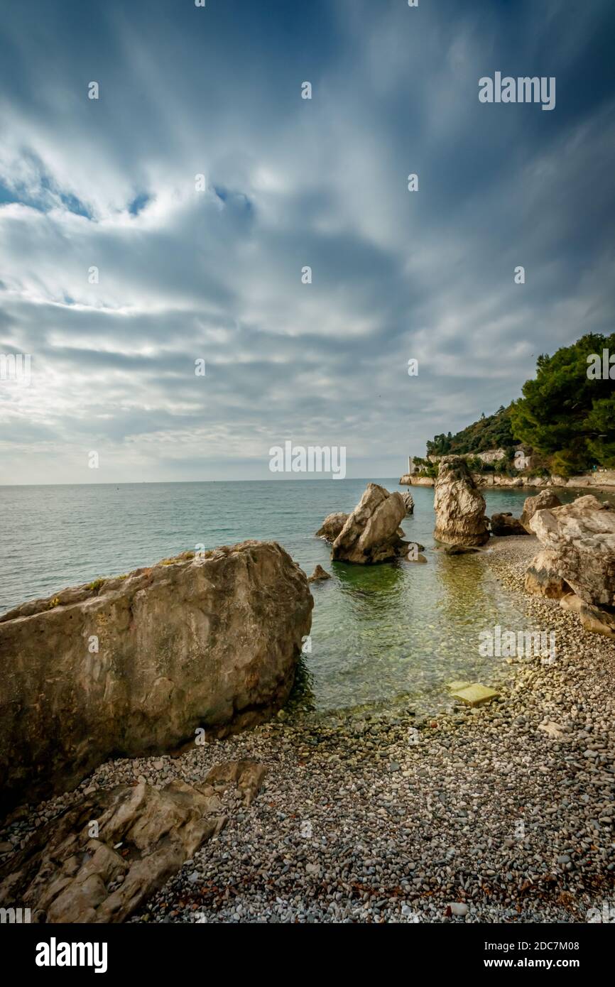 Natural rock on the water near a beach Stock Photo - Alamy