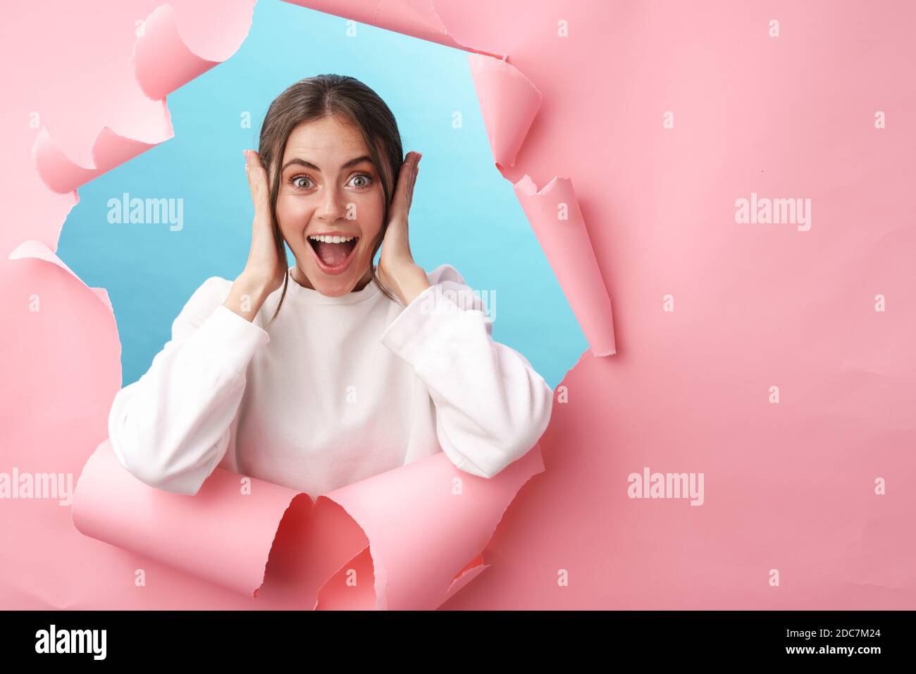 Caucasian young excited woman laughing and covering her ears isolated ...