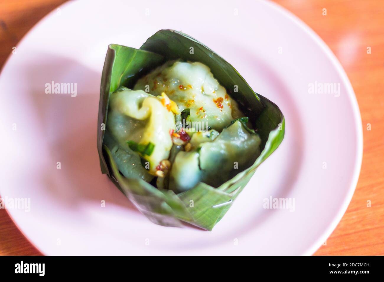 Traditional Thai rice cakes wrapped in banana leaves at a restaurant in ...