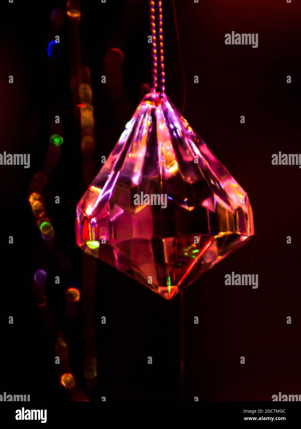 A clear, crystal shape, Christmas tree decoration, reflecting the ...