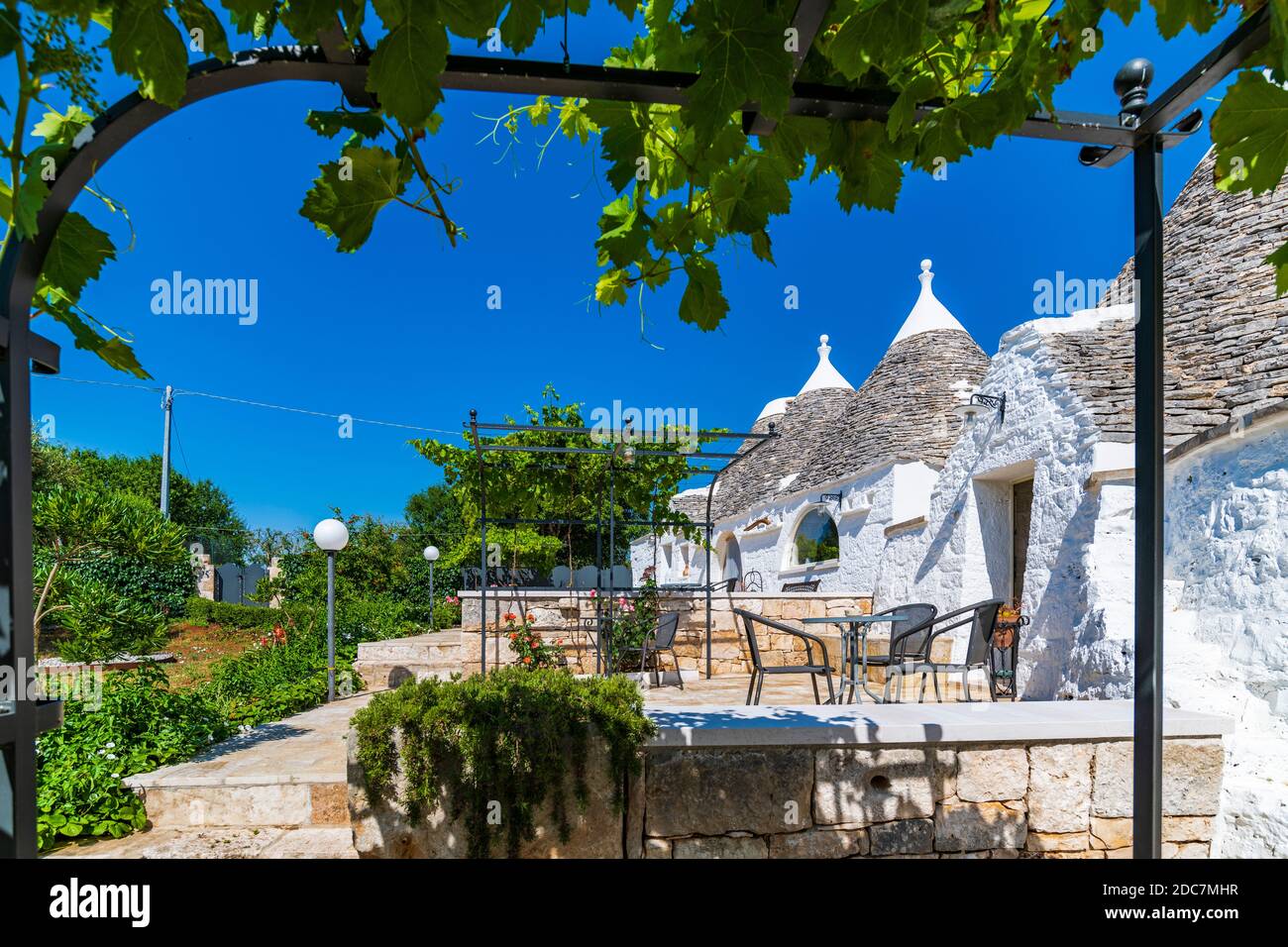 Olive trees and trulli of the Itria valley. Puglia Stock Photo - Alamy