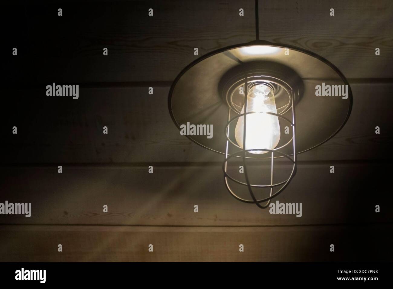 Old fashioned vintage lantern lamp burning with a soft glow light in an ...