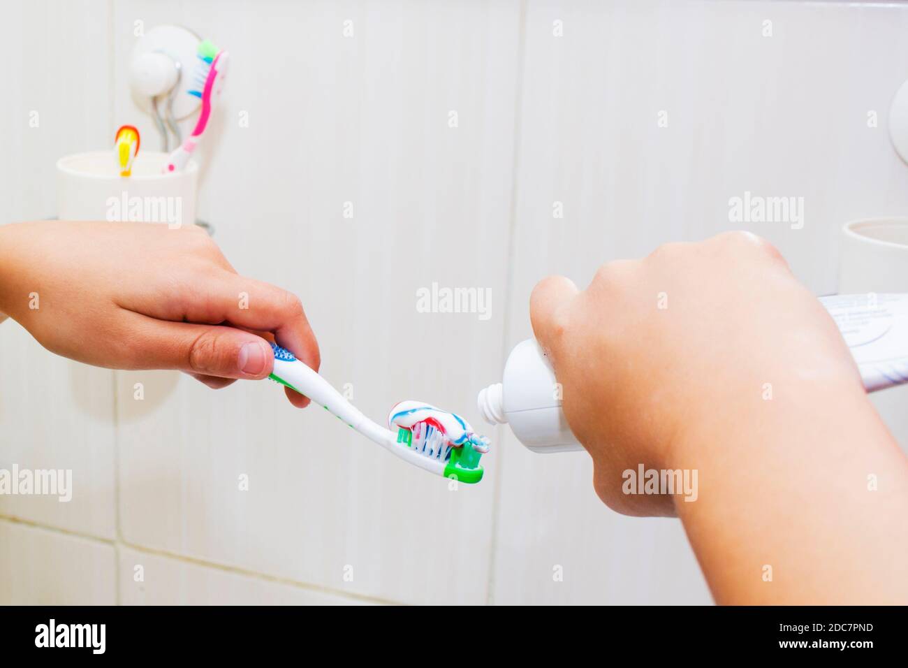 Dental care. Woman hands is holding toothbrush and placing toothpaste ...
