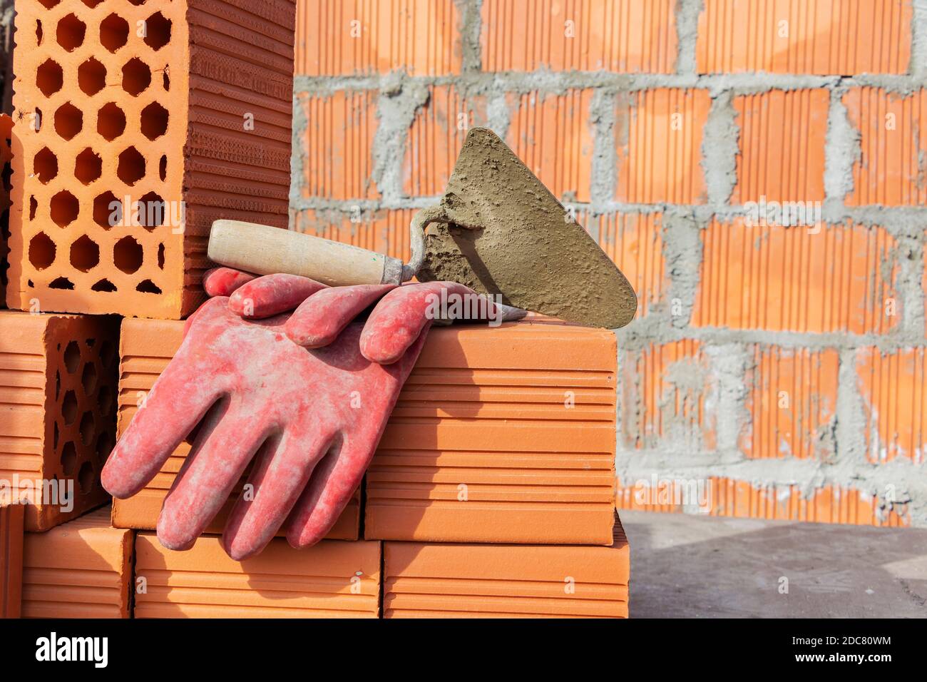 Mason bricklaying background with trowel and clay brick blocks Stock ...