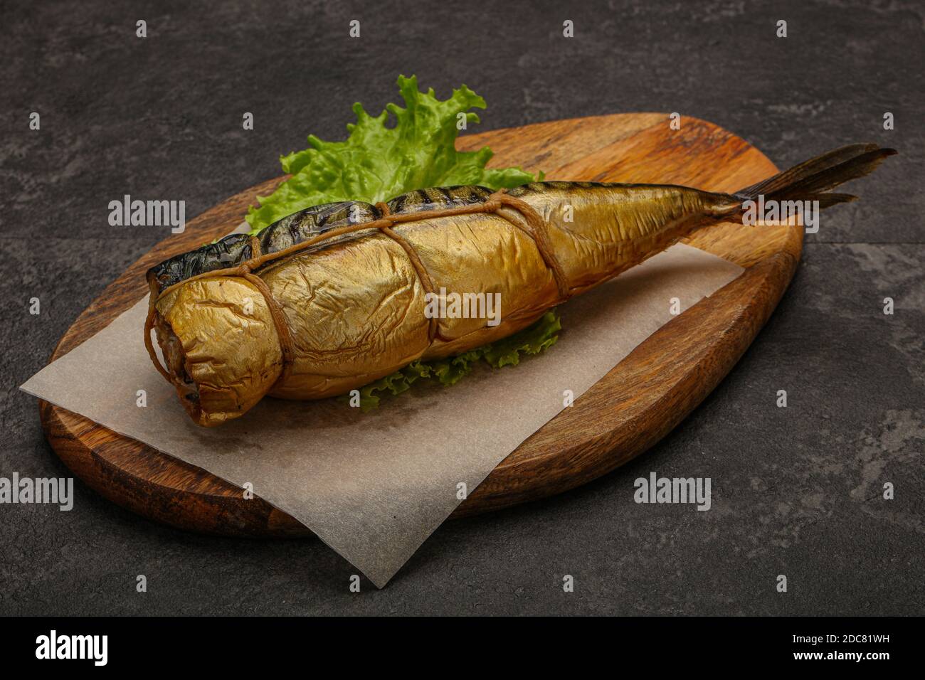 Smoked tasty mackerel fish snack over board Stock Photo - Alamy