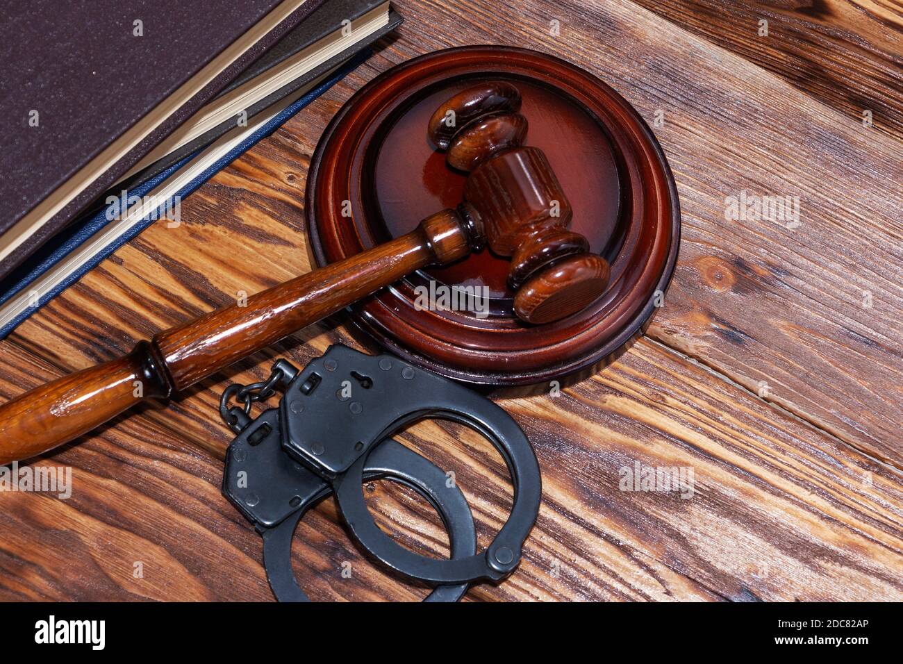 Handcuffs and a wooden gavel in front of manila folders Stock Photo - Alamy
