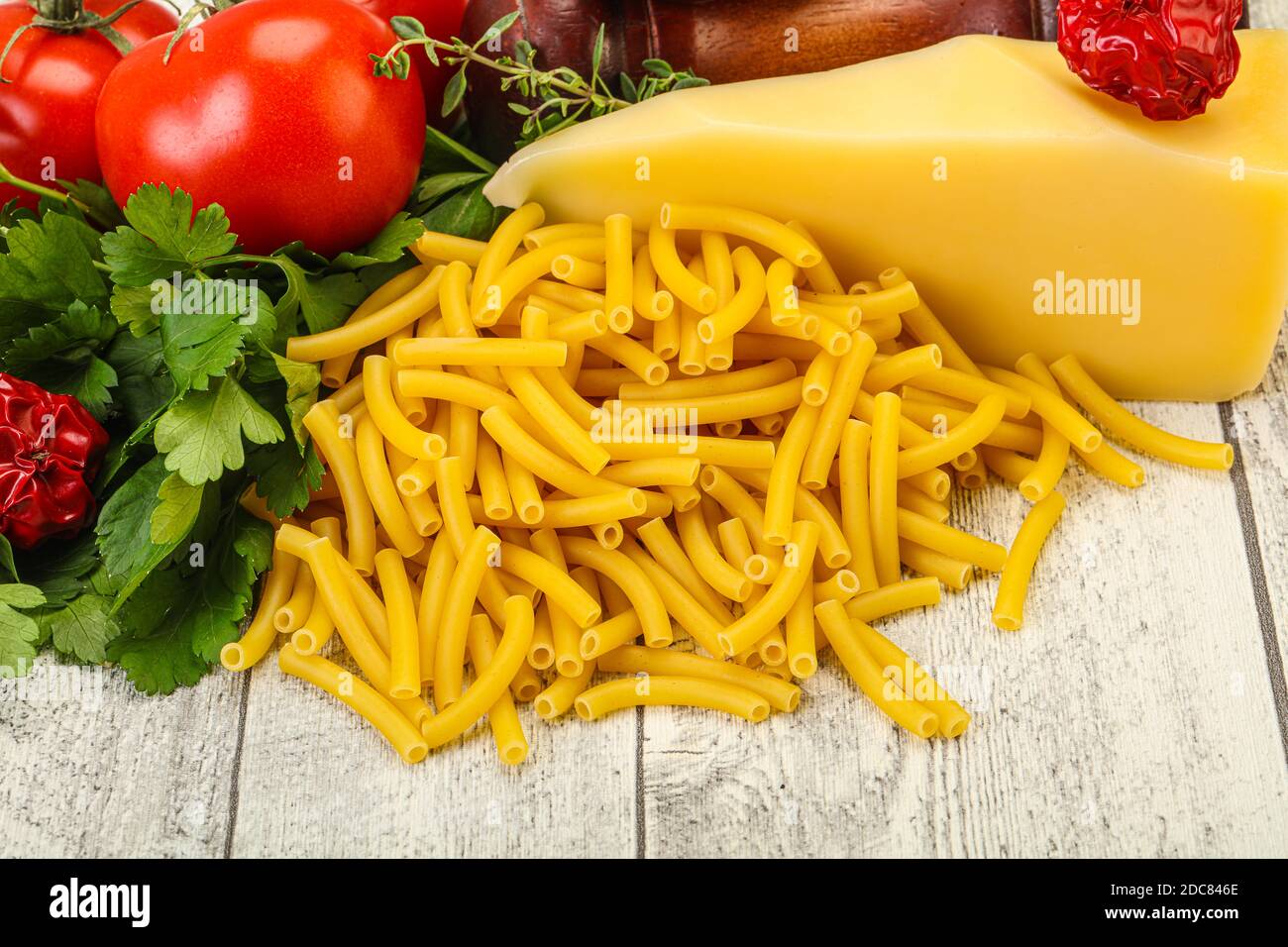 Italian pasta raw Maccheroni for cooking served vegetables Stock Photo ...
