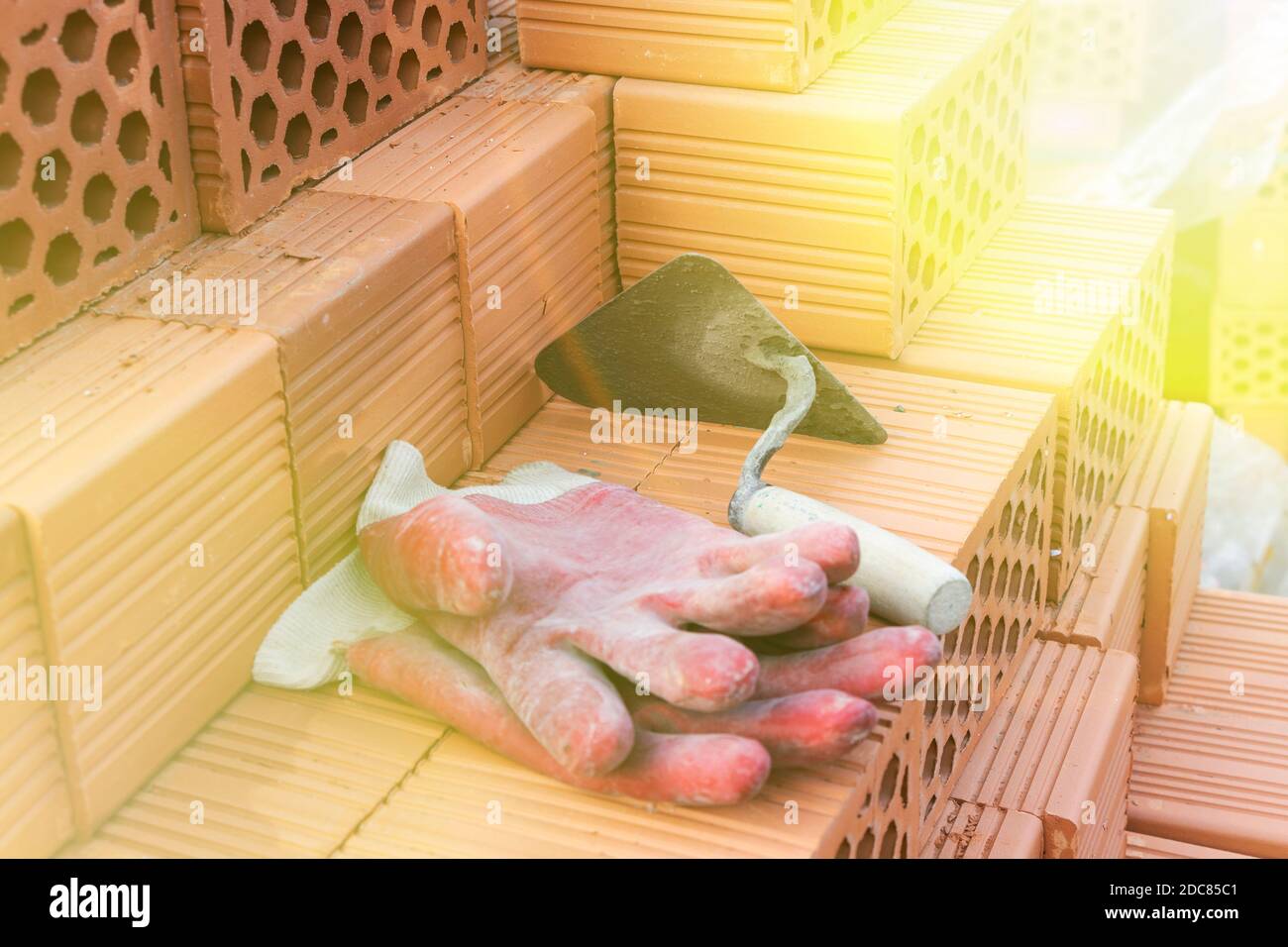 Mason bricklaying background with trowel and clay brick blocks Stock ...