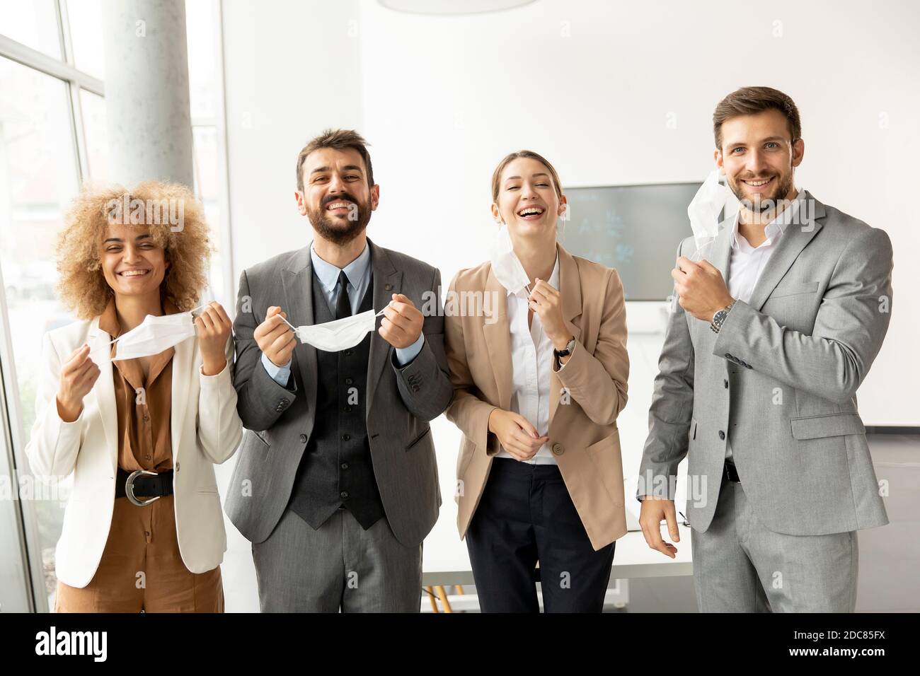 Young businesswoman taking off protective hi-res stock photography and ...