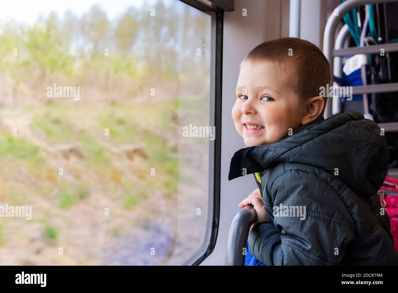 little boy looking through the bus window. Travelling with children ...