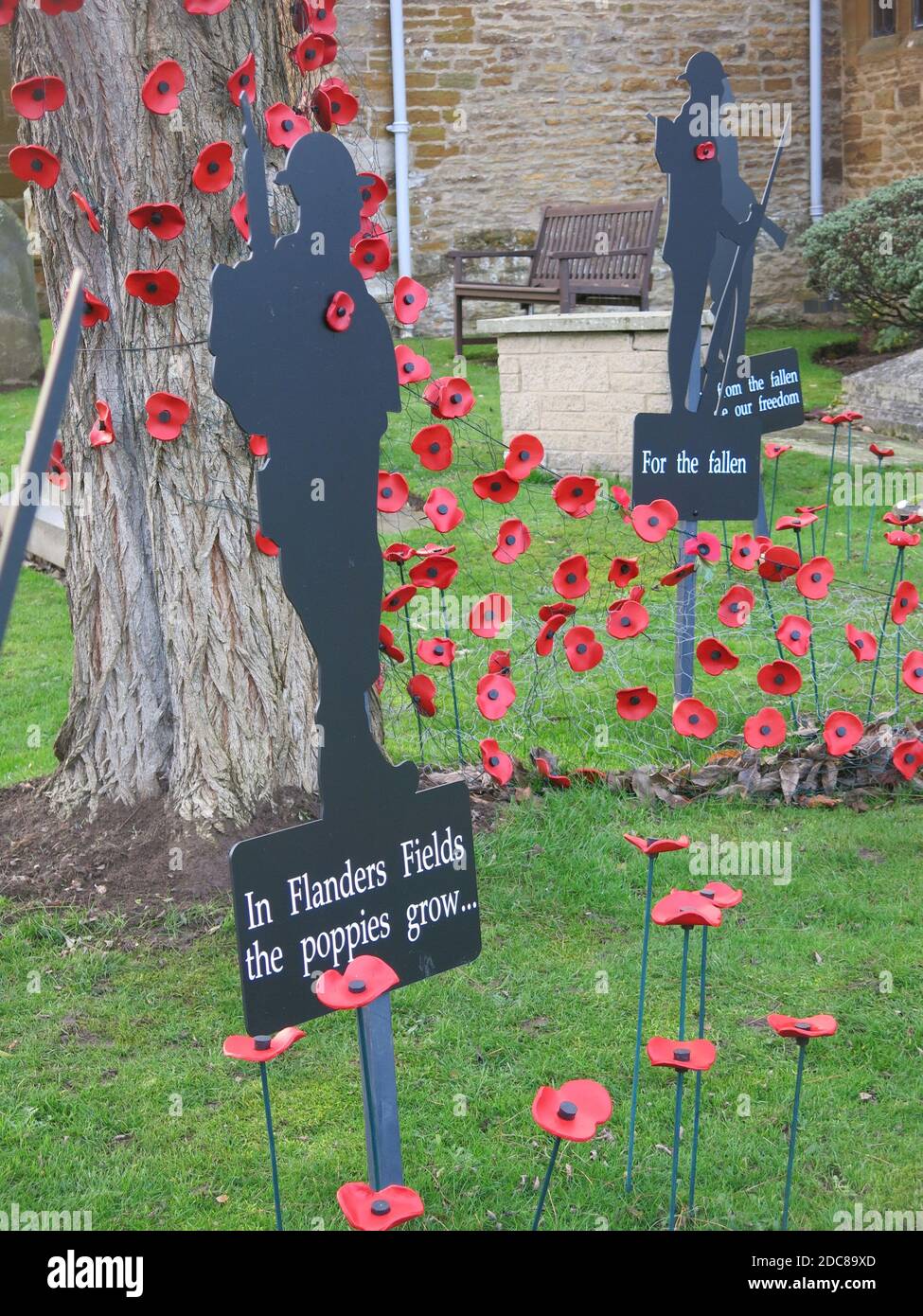 Cascading poppies and black silhouettes of soldiers in a Remembrance ...