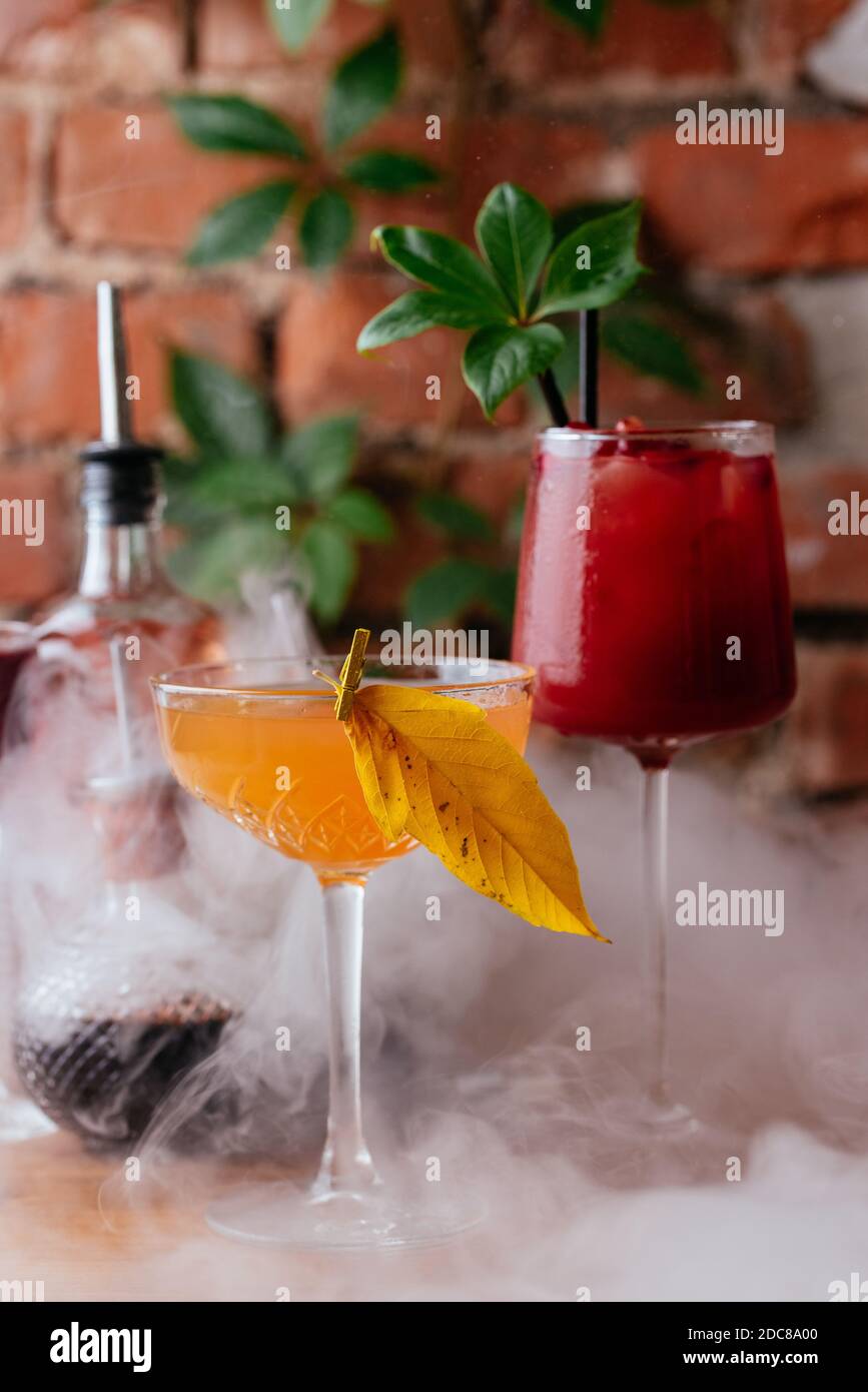 autumn cocktails on a brick wall background Stock Photo - Alamy