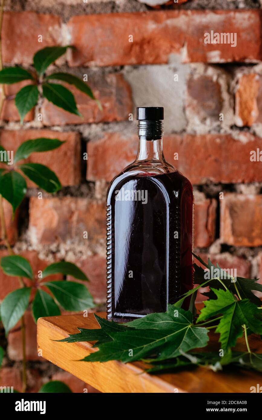 a bottle alcohol on a brick wall background Stock Photo - Alamy