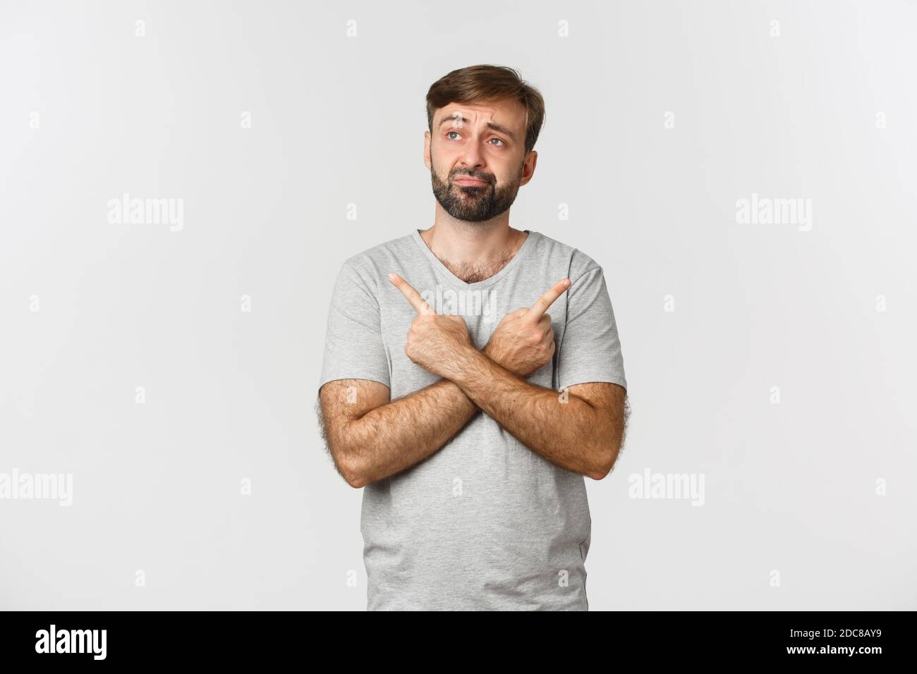 Portrait of indecisive beaded man in gray t-shirt, making decision ...