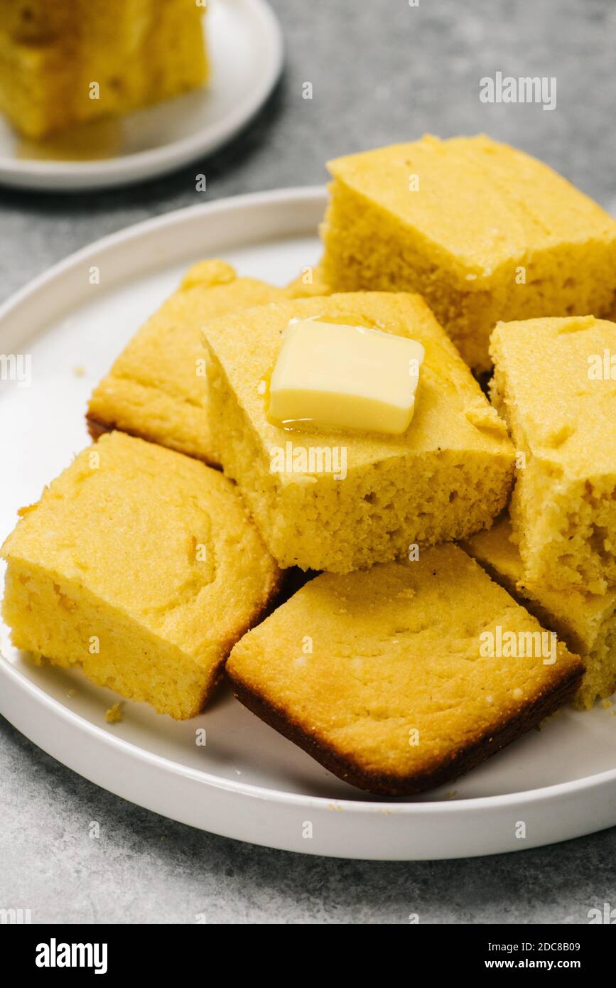 Plate of golden cornbread squares Stock Photo - Alamy