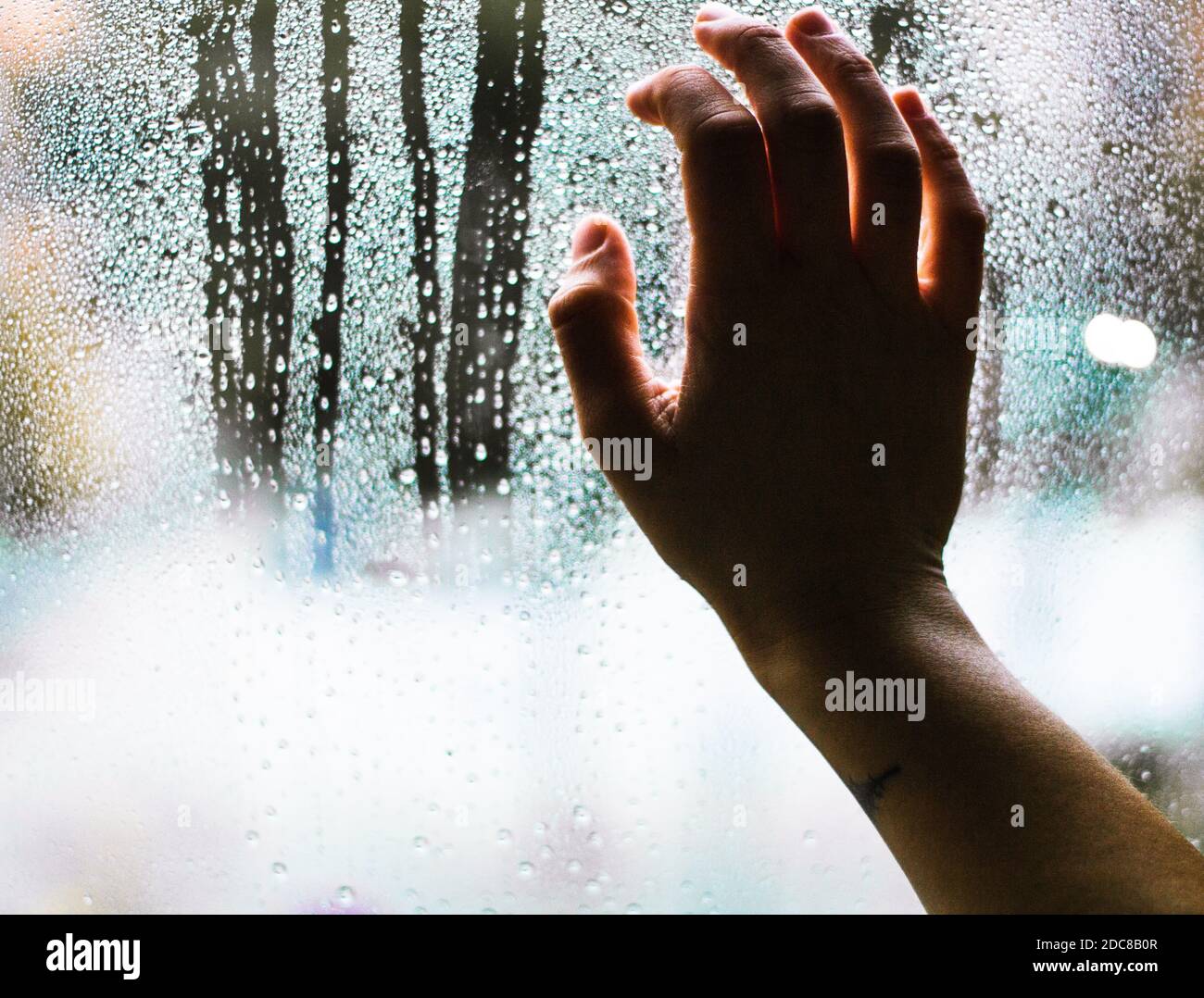 hand holding window glass with raindrops Stock Photo - Alamy