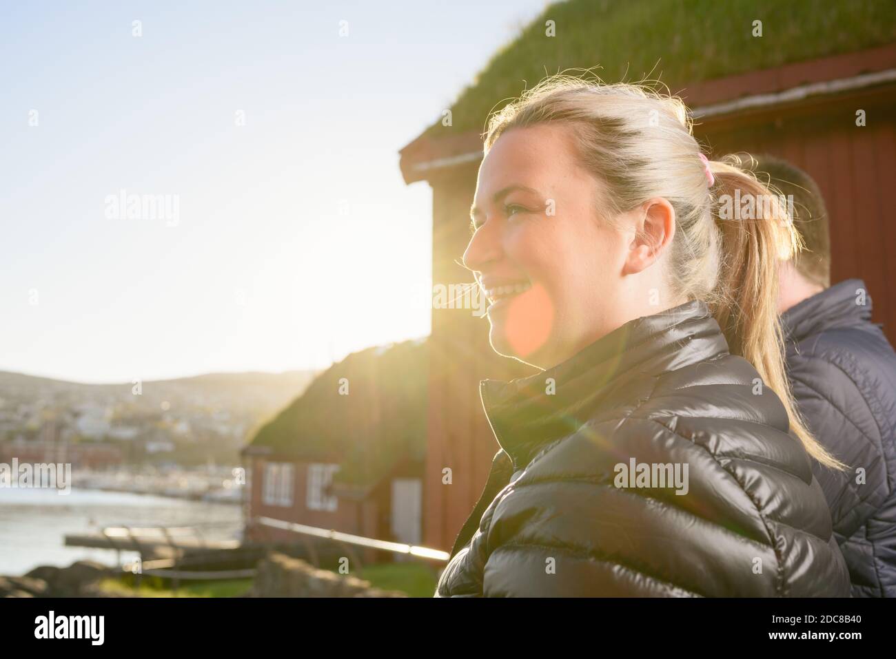 Side view of smiling female tourist enjoying sunny day during vacation ...