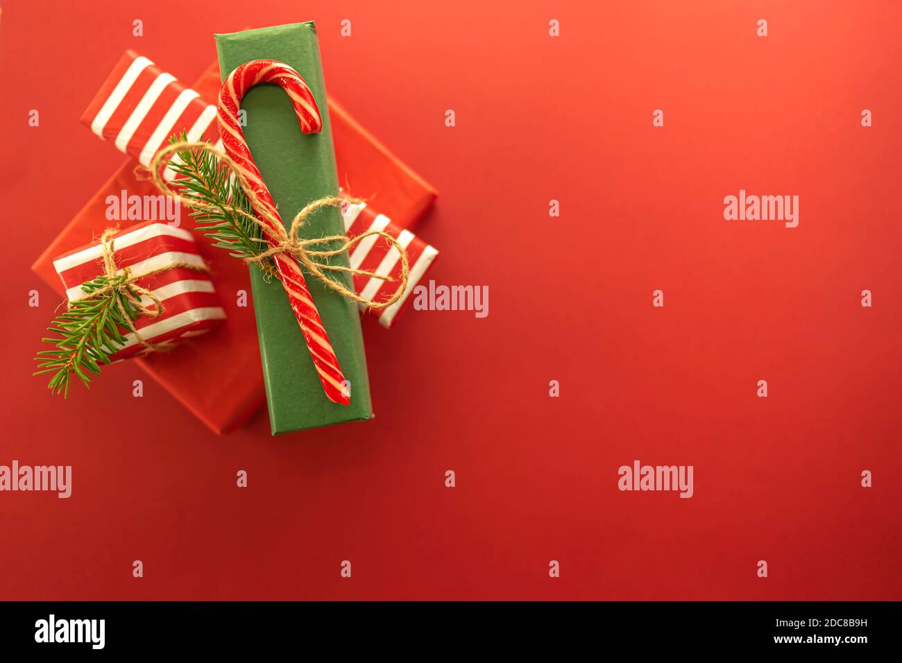 Christmas candy cane and presents are wrapped in a coloured paper Stock ...