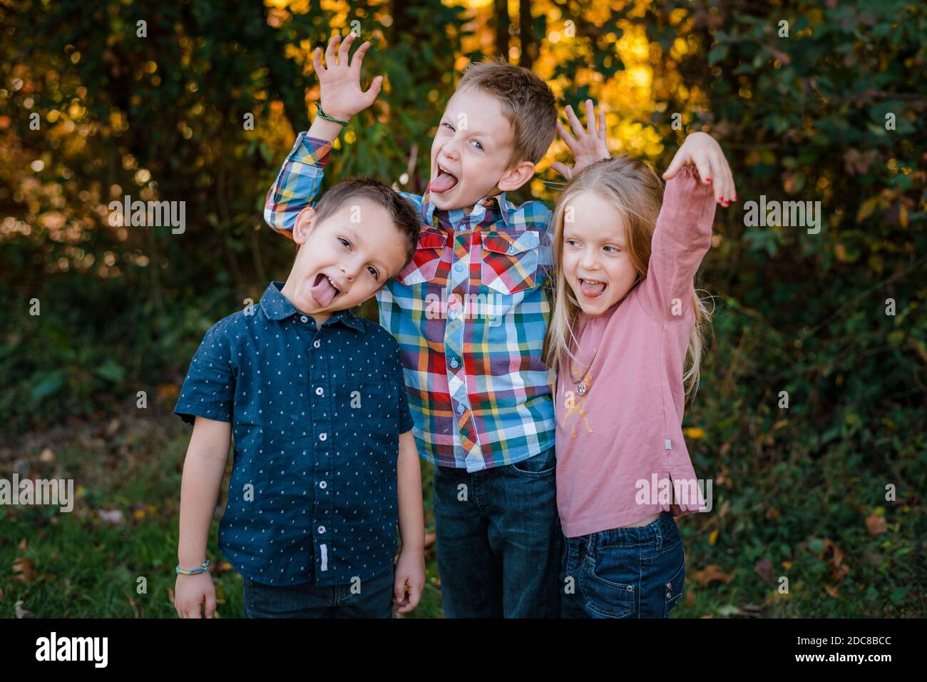 Siblings brothers and sisters being silly during family portrait Stock ...