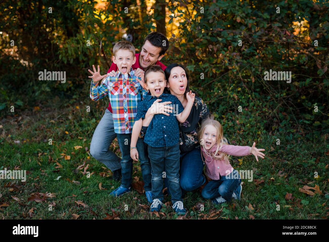 family portrait with mom, dad, brother, sister making silly faces Stock ...