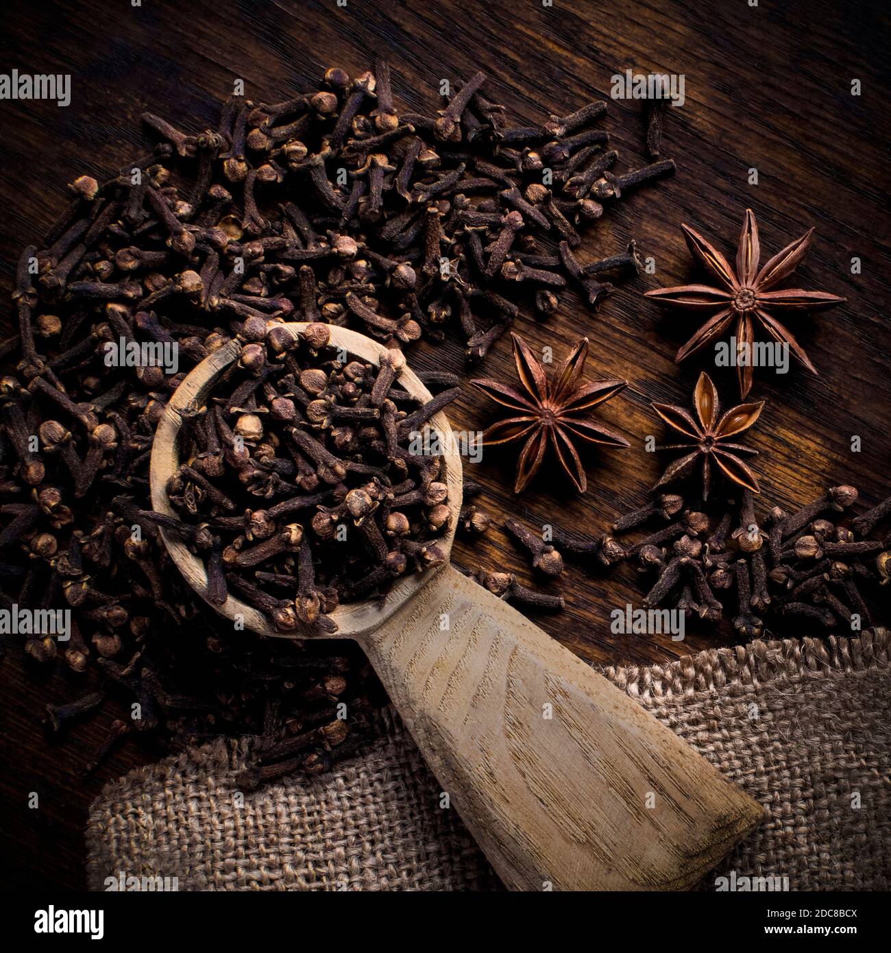 Top view composition with aromatic dried clove buds in wooden spoon ...