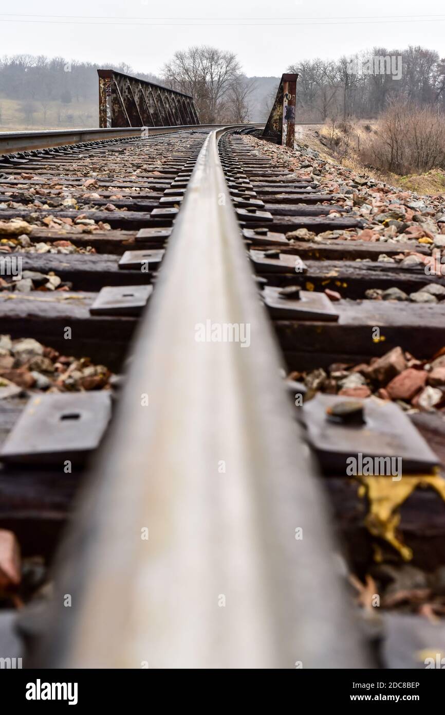 Empty freight train railway tracks winding through the rural ...