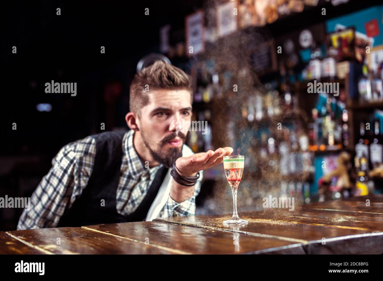 Professional bartending decorates colorful concoction in cocktail bars ...