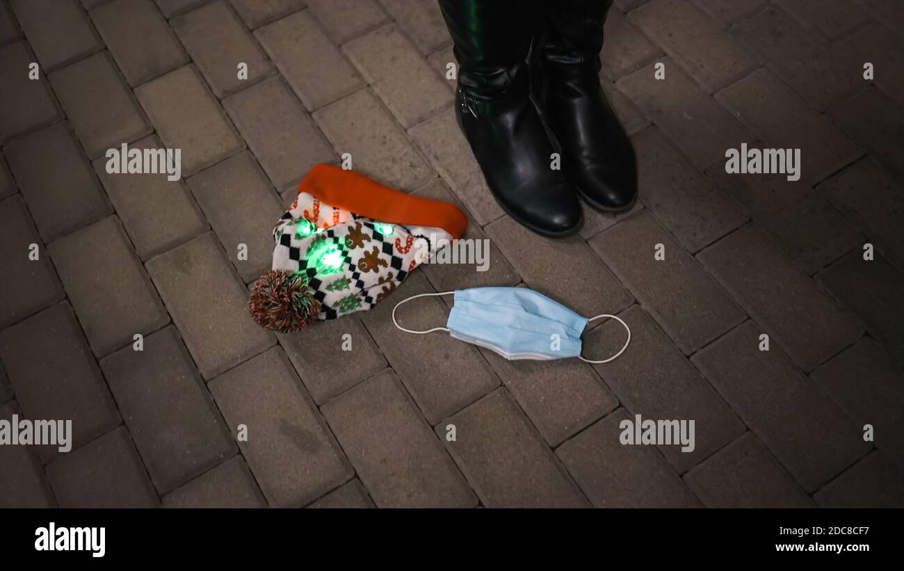 Female legs walk away from Xmas hat and medical face mask Stock Photo ...