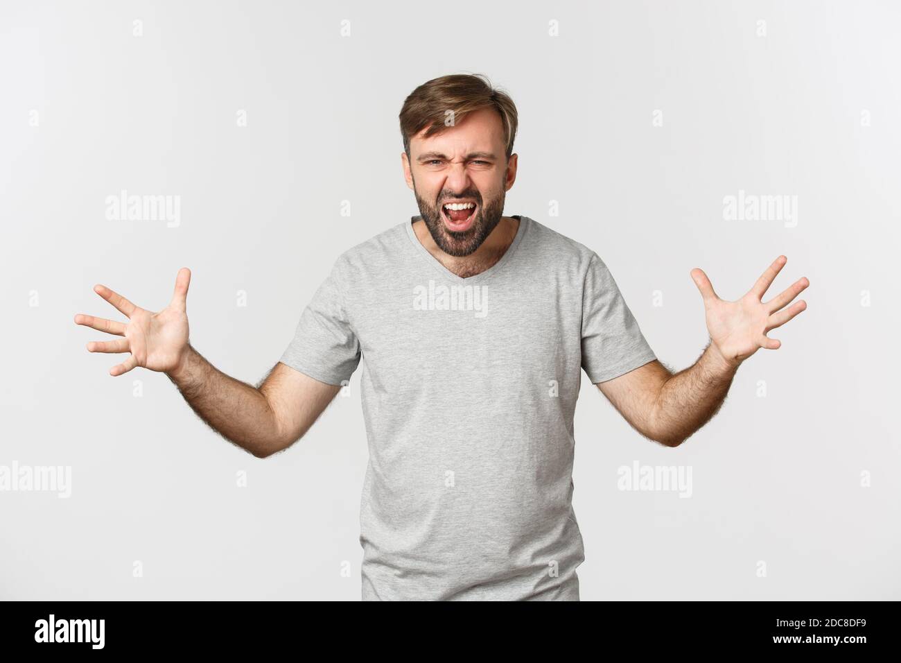 Portrait of angry bearded man, shouting and shaking hands frustrated ...