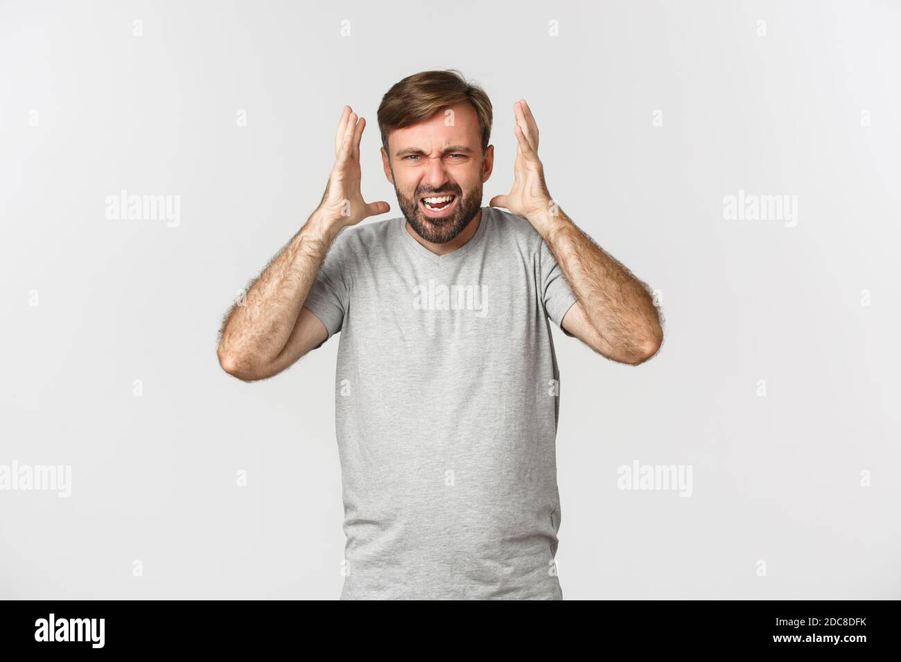 Portrait of angry bearded man, shouting and shaking hands frustrated ...