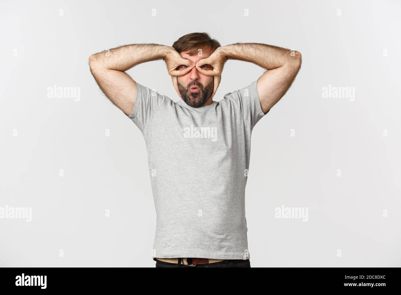 Portrait of funny caucasian guy making faces and mocking someone ...