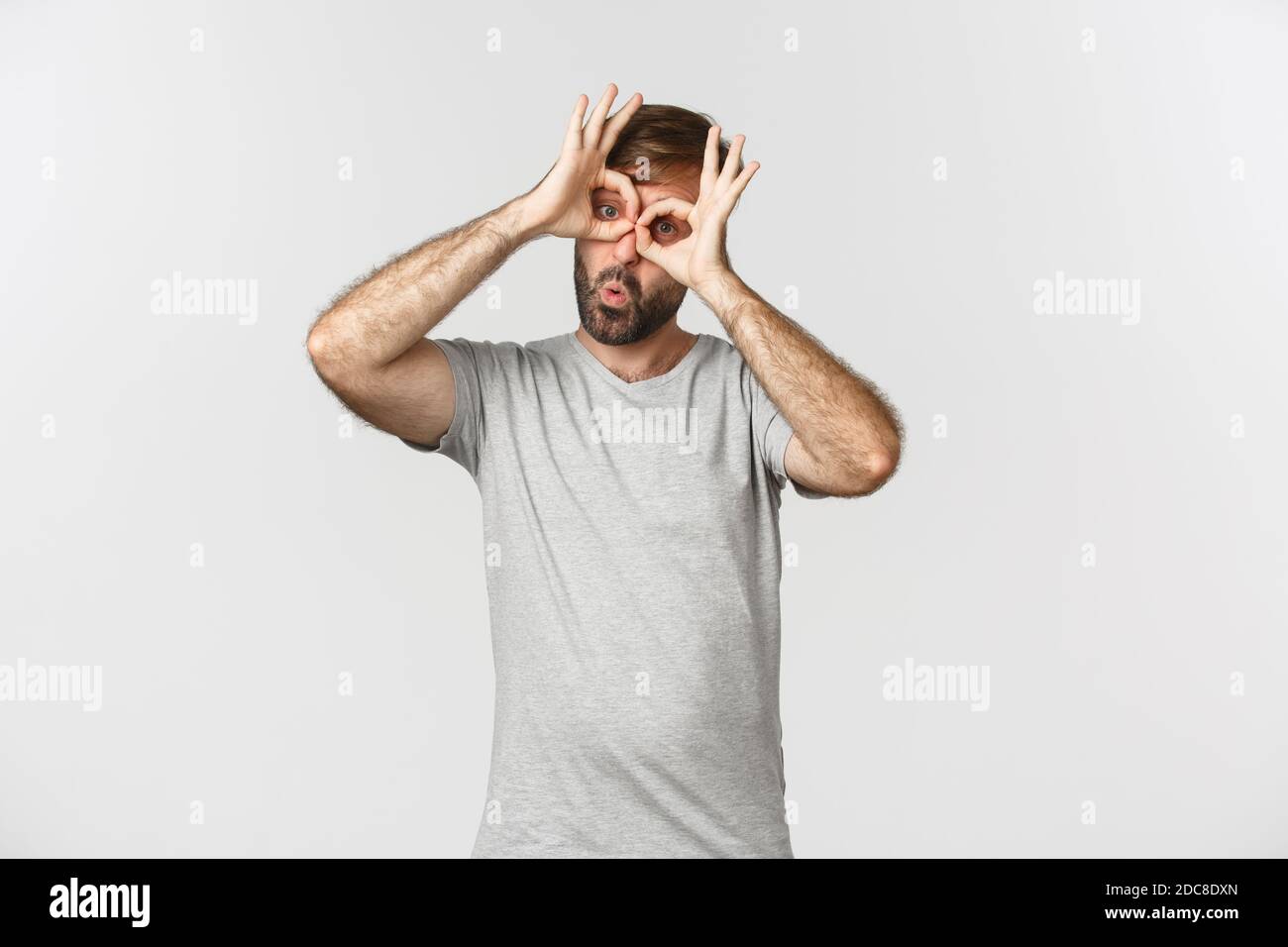 Portrait of funny caucasian guy making faces and mocking someone ...