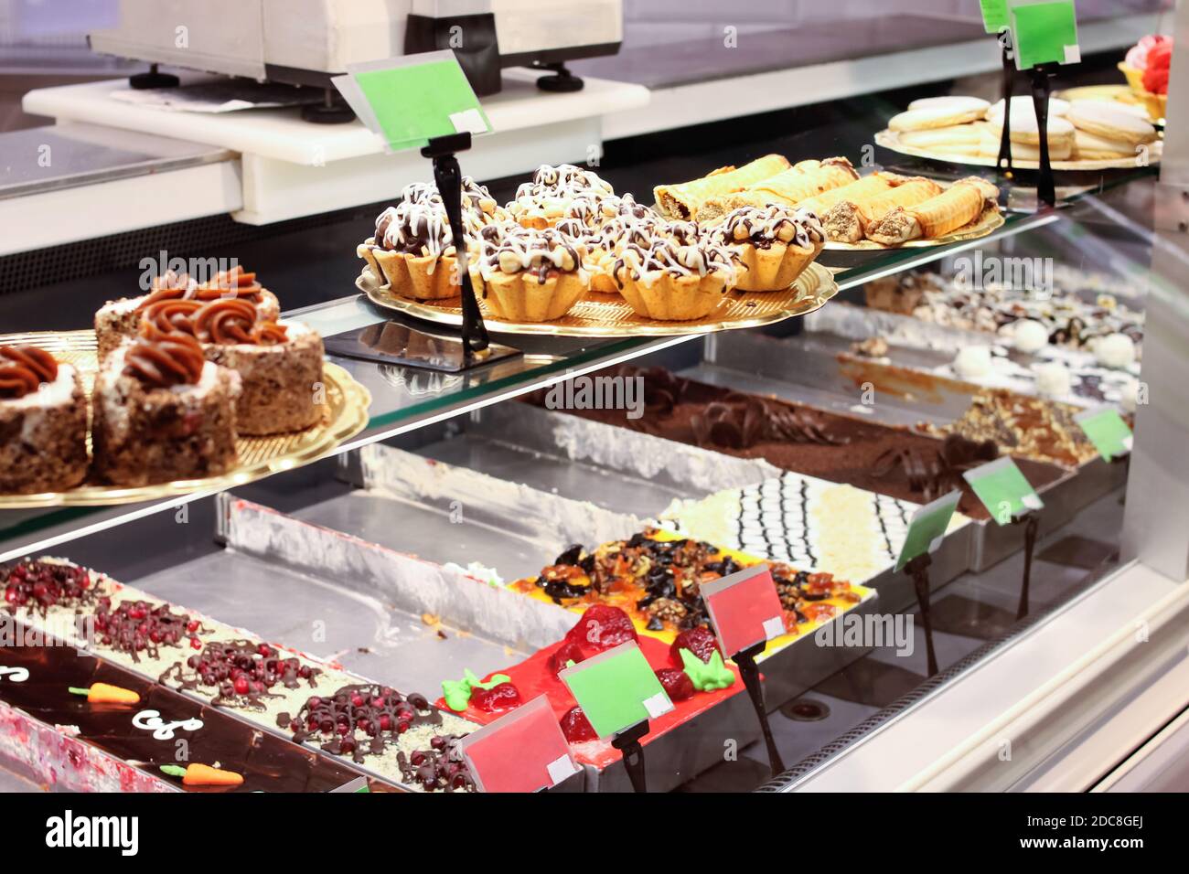 Bright cakes on a shop window close up Stock Photo - Alamy