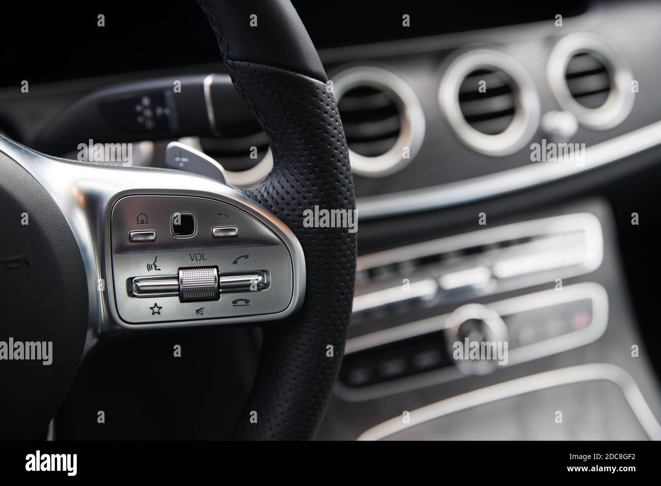 audio control buttons on the steering wheel of the car at shallow depth ...